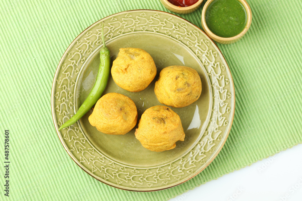 Indian snack aloo vada or bonda made from potato with coconut chutney ...