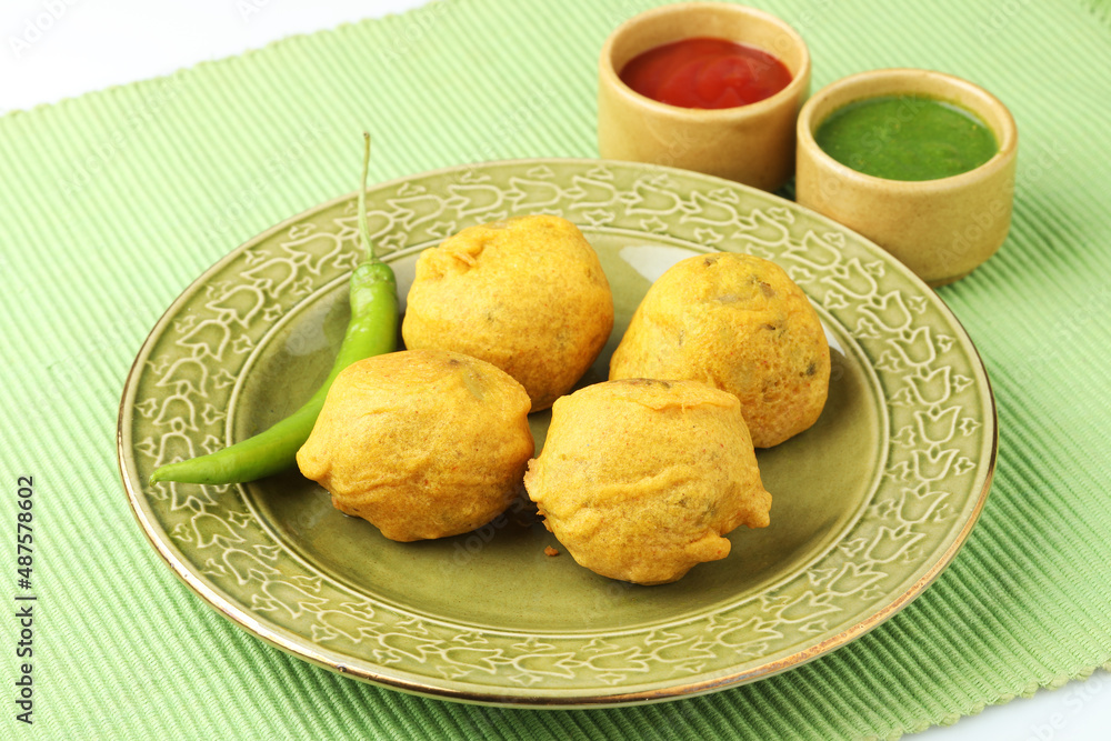 Indian snack aloo vada or bonda made from potato with coconut chutney ...