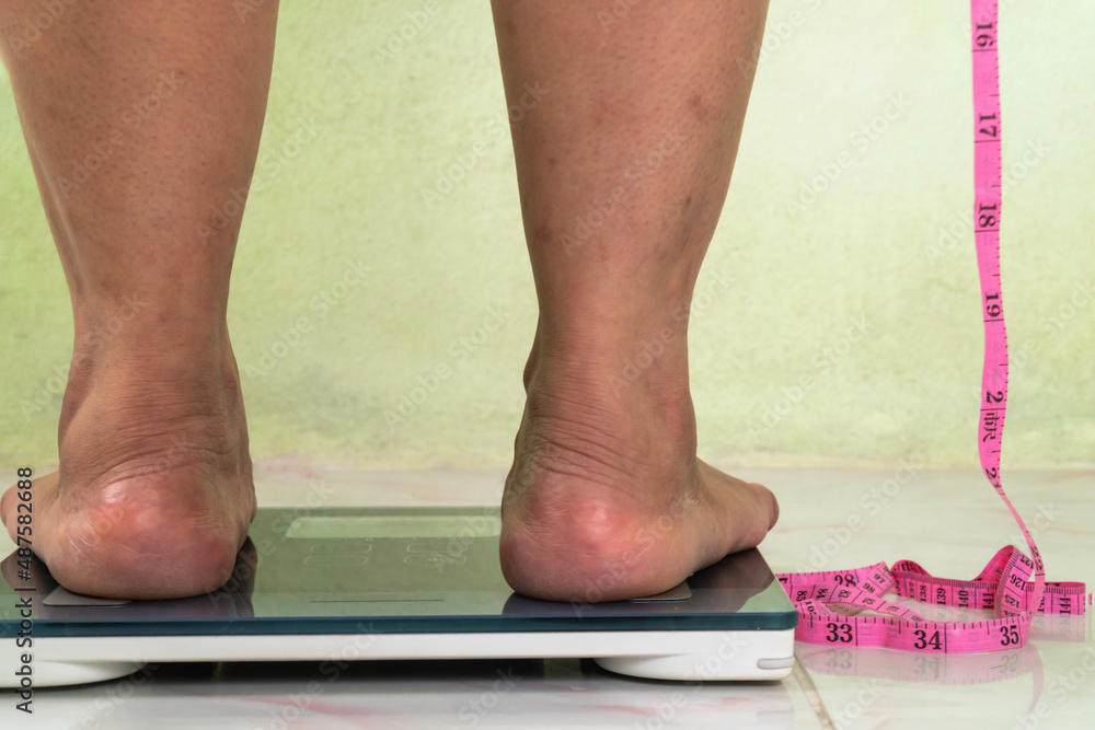 feet on a scale Stock Photo | Adobe Stock