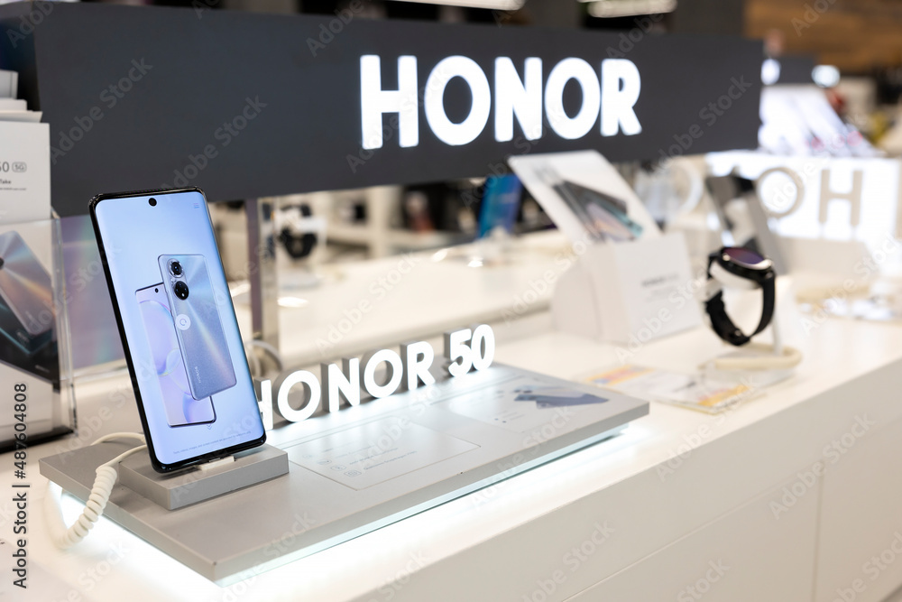 Honor 50 5G mobile smartphone on retail display in store. Brand logo in ...