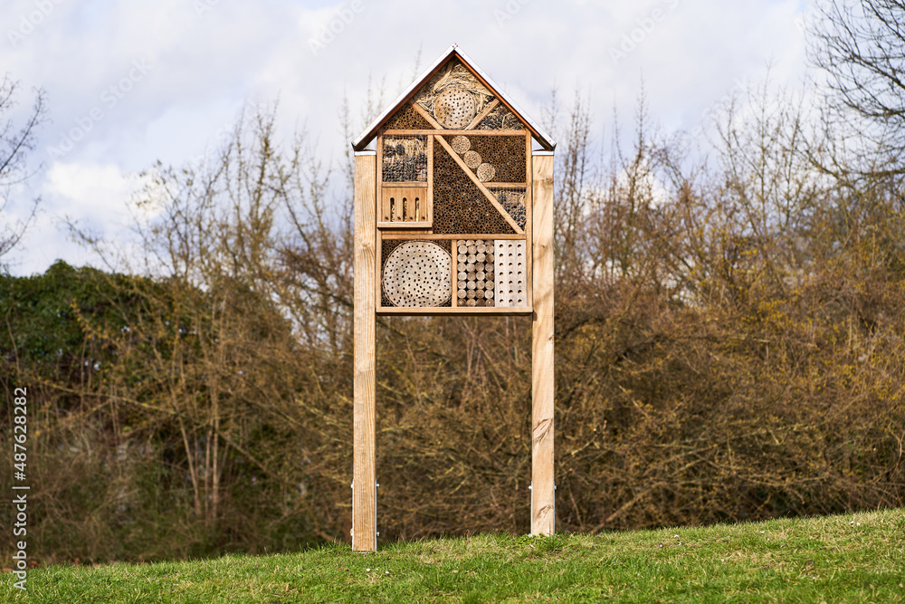 Insect house on the meadow. Protection for animals and environment. It ...