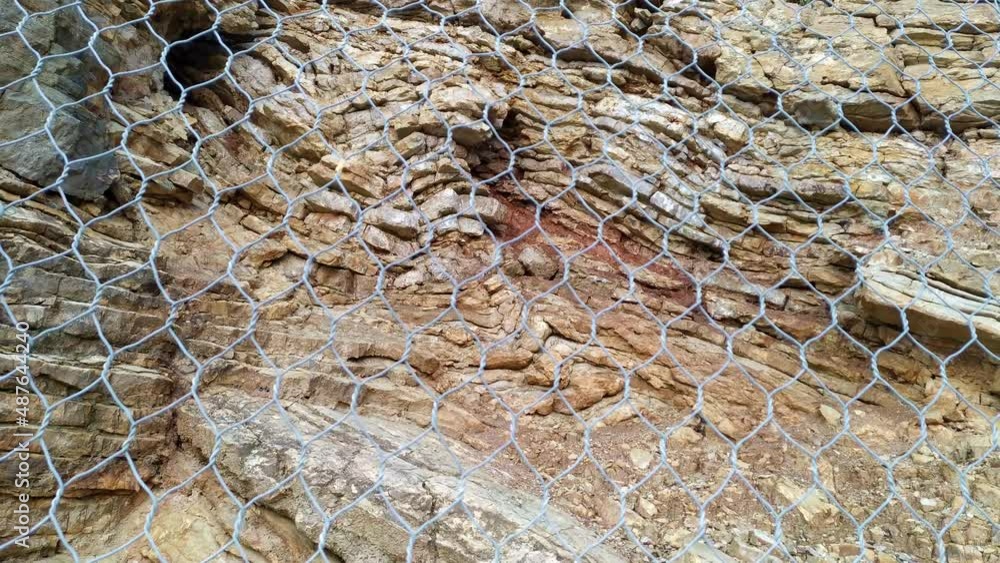 Wire mesh metal net protection against falling rocks. Metal net on a ...