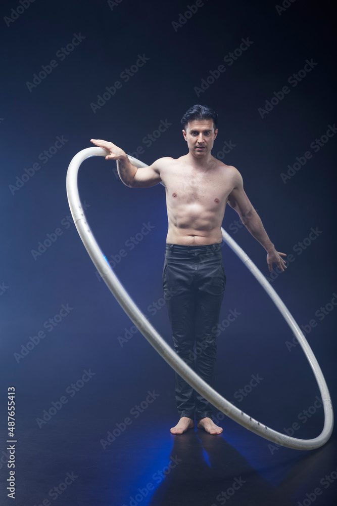 Circus performer artist with muscles body in a Cyr Wheel (Roy Cyr ...