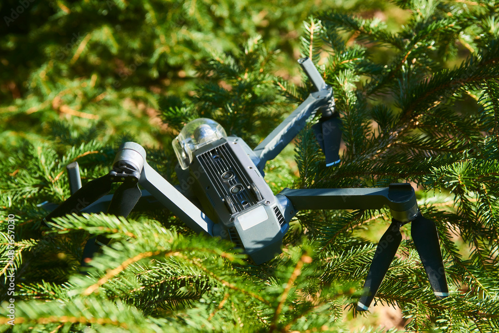 Drone quadcopter accident scene. UAV Quadrocopter crashed on tree in ...