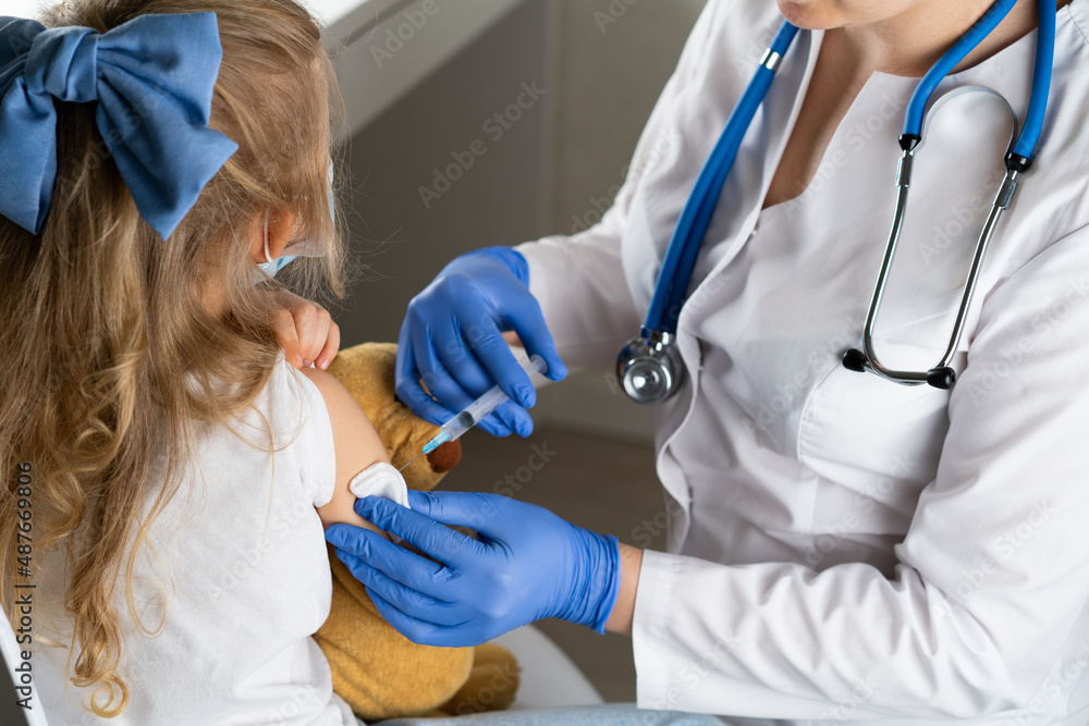 vaccination of children, a little girl at a doctor's appointment, an ...