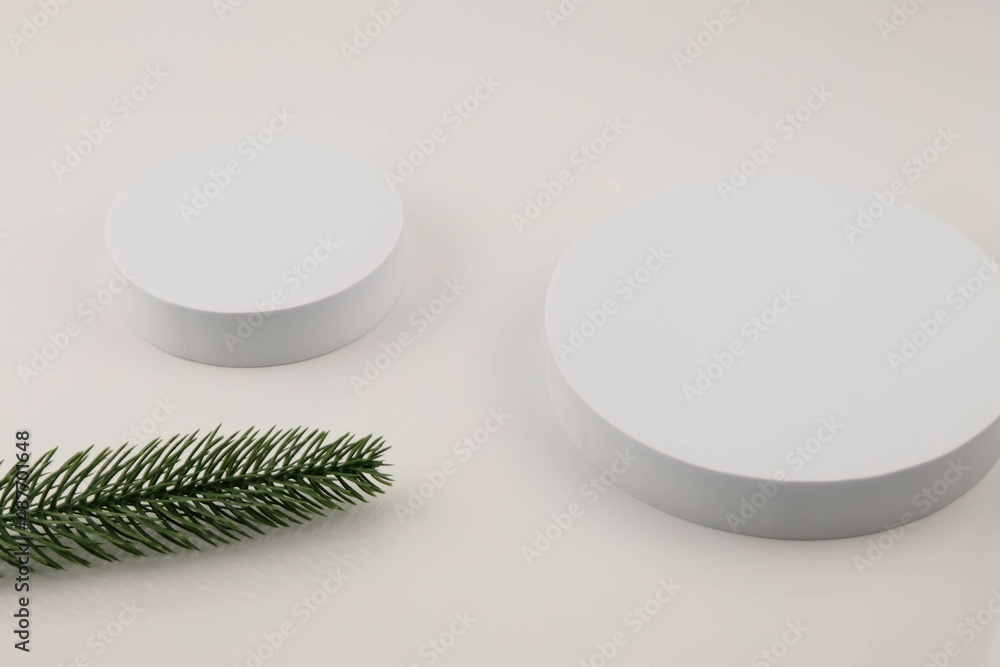 White background with white pallet props and green pine leaves ...