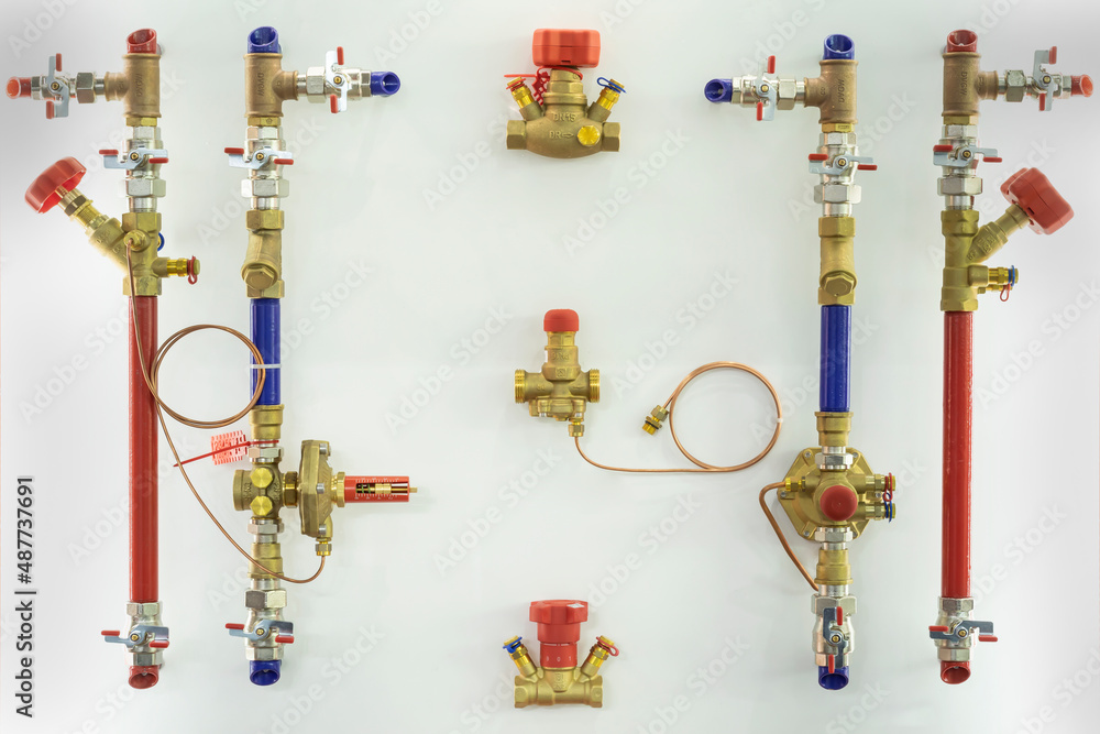 Pipes and valves on a white wall, two-pipe and single-pipe system on a ...