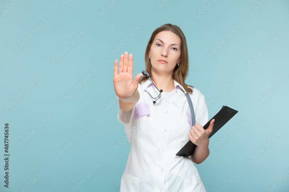 Beautiful woman doctor with a stethoscope and a black tablet, shows a ...