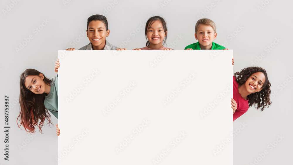 Happy Diverse Kids Hiding Behind Empty White Board, Gray Background ...