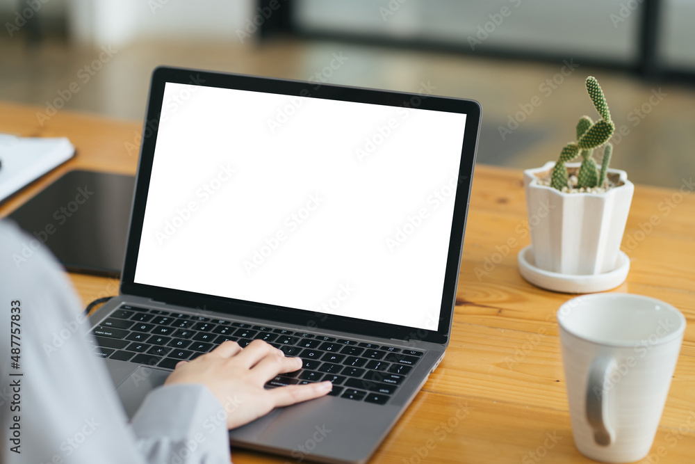 Close up image of a female assistant working on laptop computer at her ...