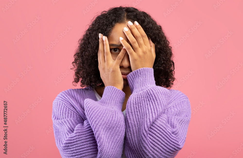 Shocked young black woman feeling frightened, covering face in fear on ...