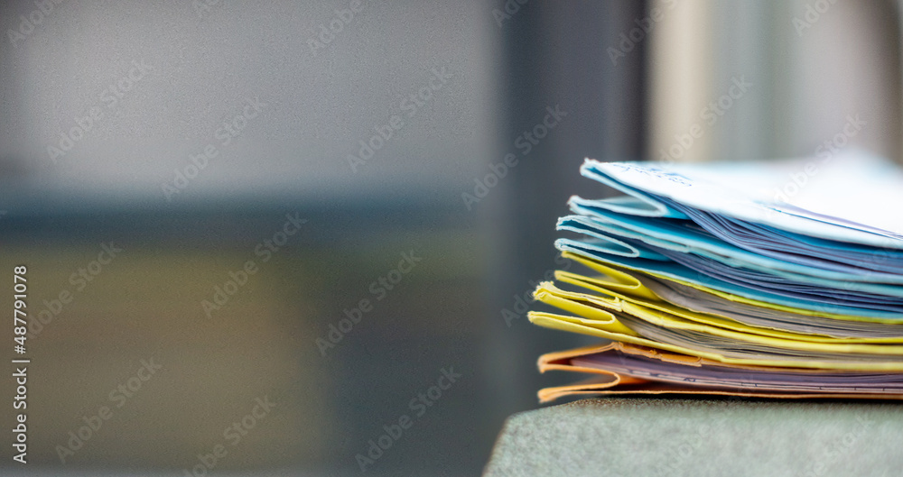 Colorful document folders are arranged vertically on the office desk ...