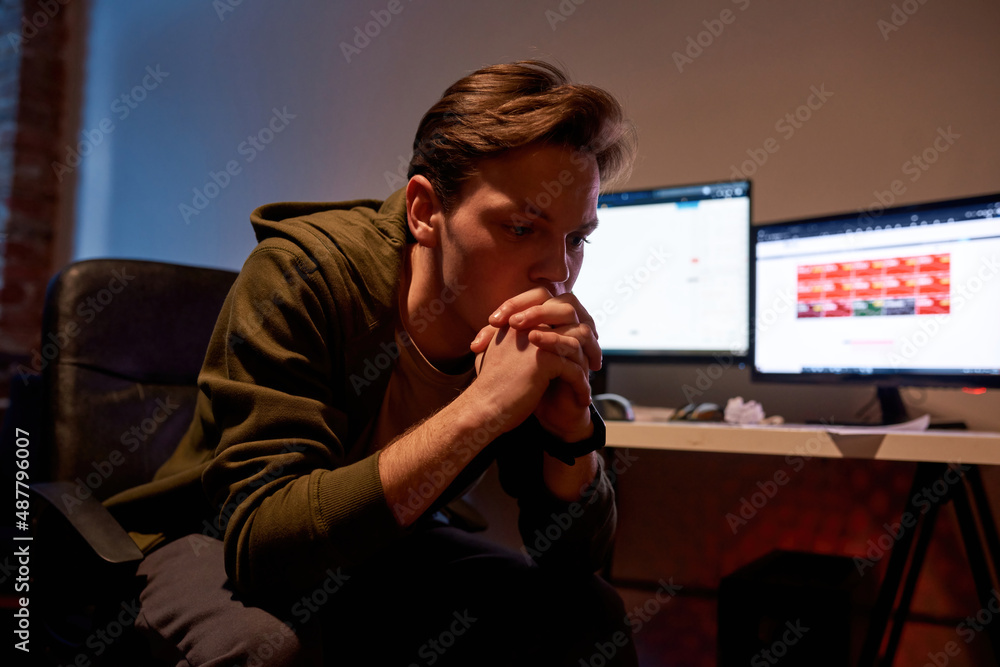 Sad male trader near desk with stock market data Stock Photo | Adobe Stock