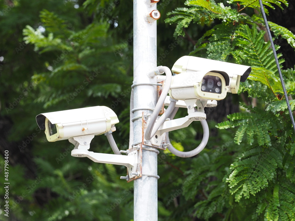 Four surveillance cameras are mounted on steel poles along the ...