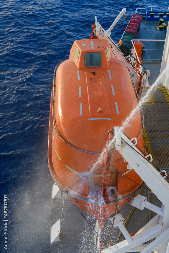 Hose pressure water test of totally enclosed lifeboat. Watertight test ...