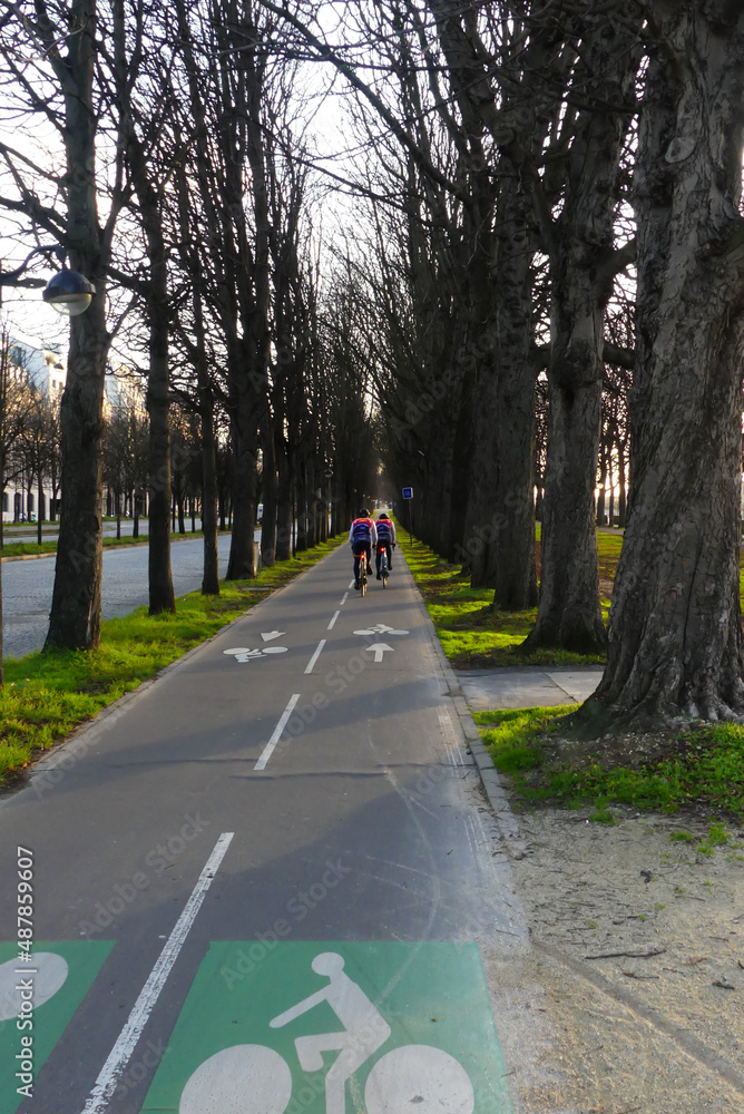Paris, France. January 30. 2022. Two people riding a bicycle through ...