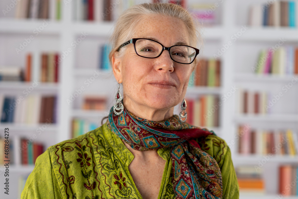Portrait of a beautiful smiling 55 year old mature woman with grey hair ...