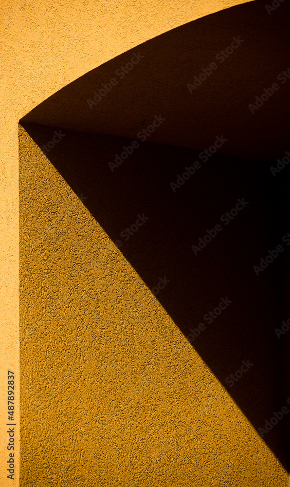 geometrical shapes angles from shadows cast on exterior orange cement ...