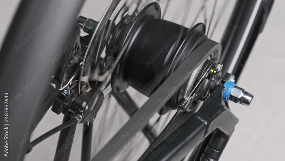The planetary gear on a belt driven bike is rotating. Close-up. Modern ...