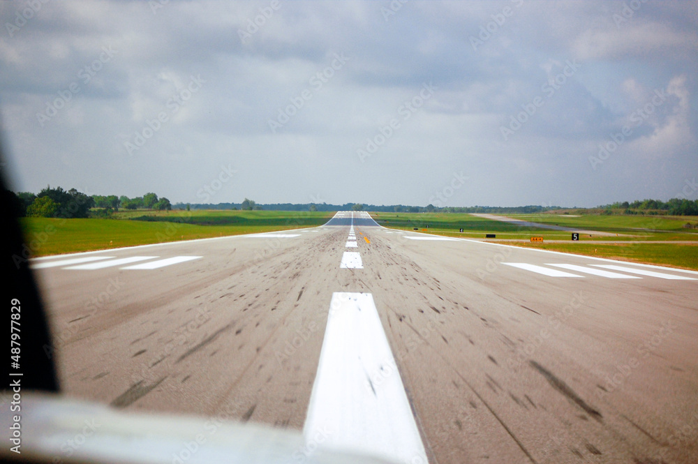 Airplane landing strip viewed from the plane cockpit window while ...
