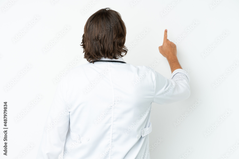 Senior dutch man isolated on white background wearing a doctor gown and ...