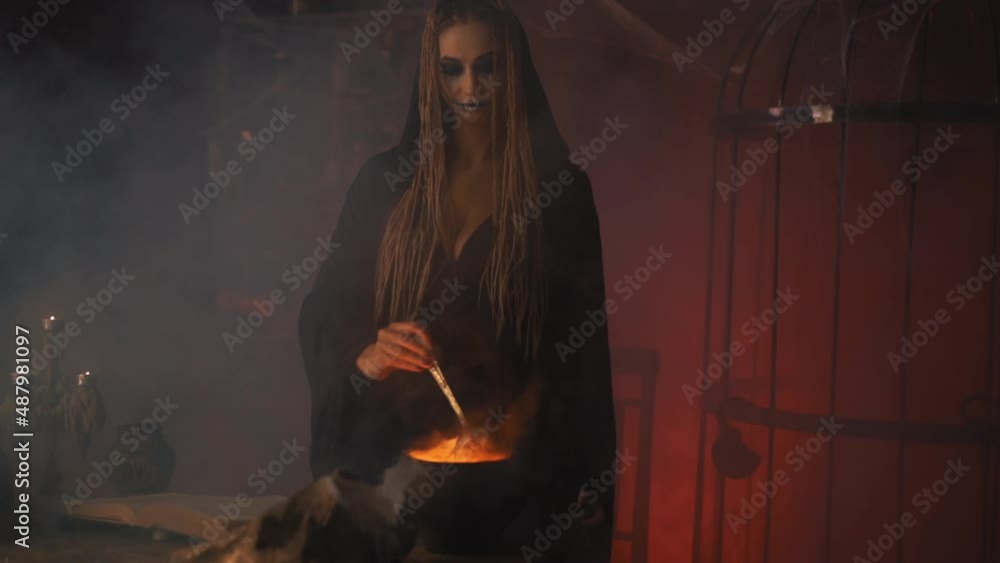 Halloween, witch use magic book and cauldron prepare poison or love ...