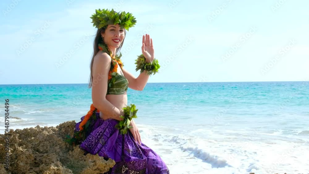 Smiling woman shakes hand saying hello. Hula dancer posing on a ...