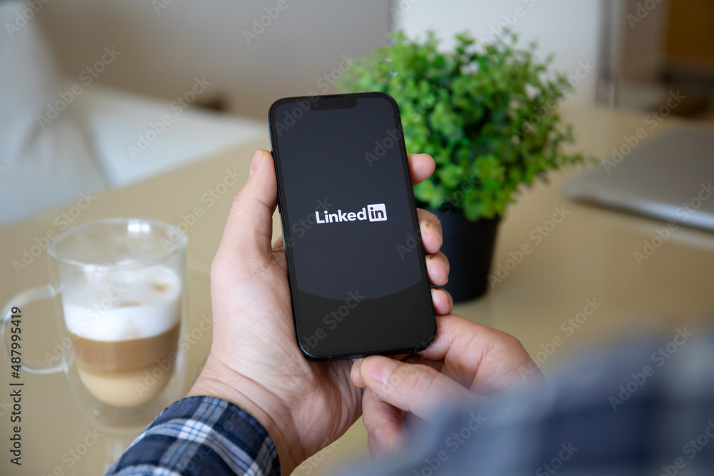 Man hand holding iPhone 13 Pro Graphite with app LinkedIn Stock Photo ...
