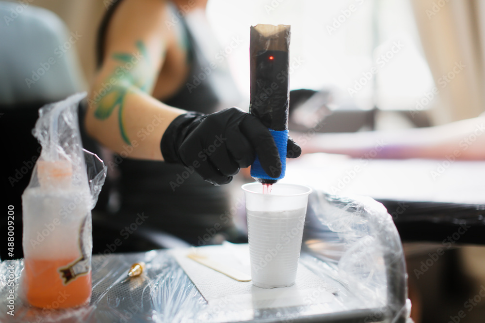 Tattoo Parlor Pretty European Red Haired Girl Makes A Tattoo On Arm