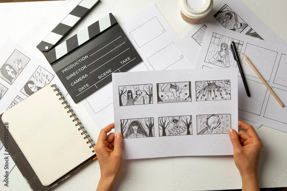 Storyboard in the hands of the artist. Drawn characters for a movie or ...