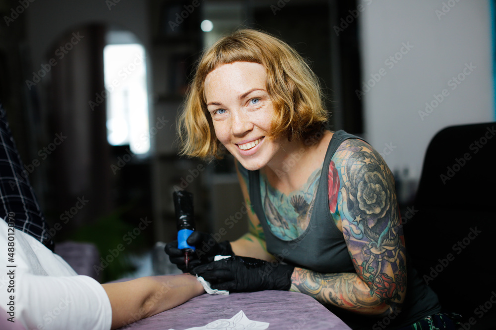 Tattoo Parlor Pretty European Red Haired Girl Makes A Tattoo On Arm