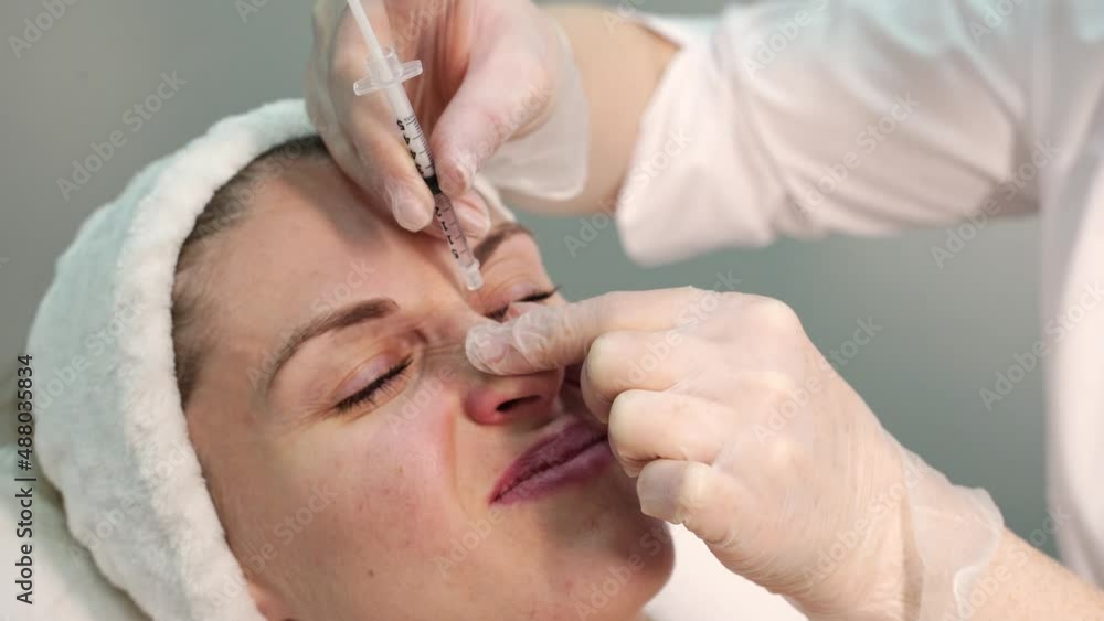 Injection at spa salon. Doctor hands in gloves. Closeup. Pretty female ...