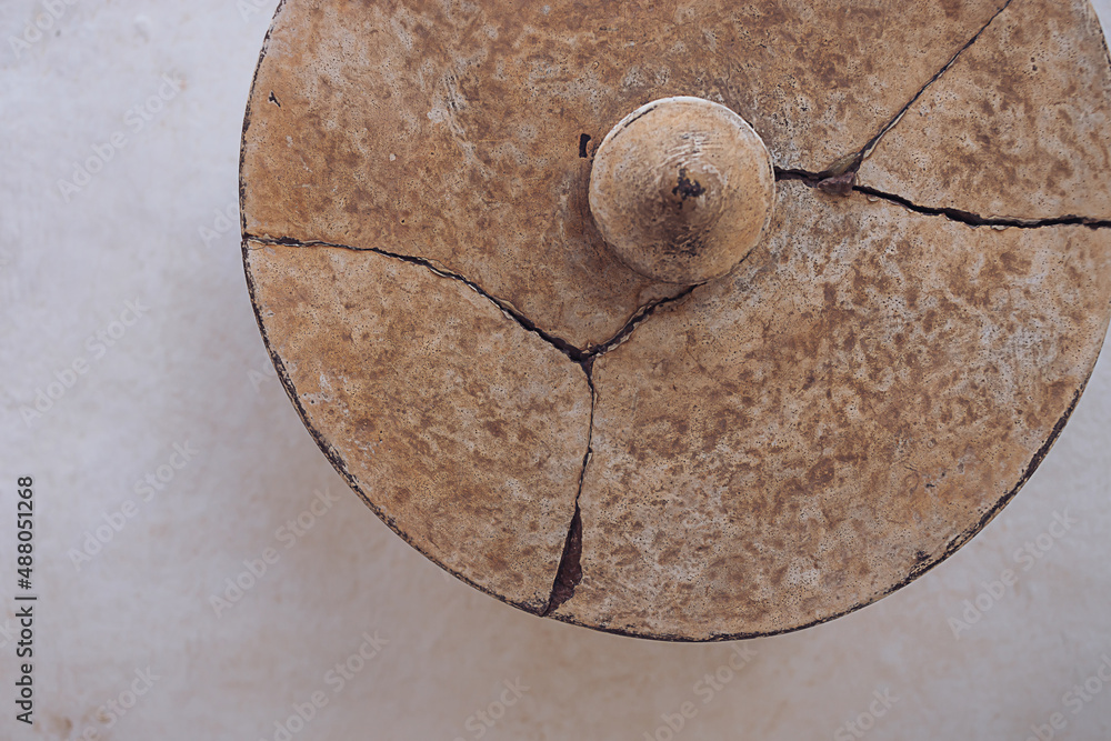 Aged ceramic pot with lid on a white wall with cracks background ...