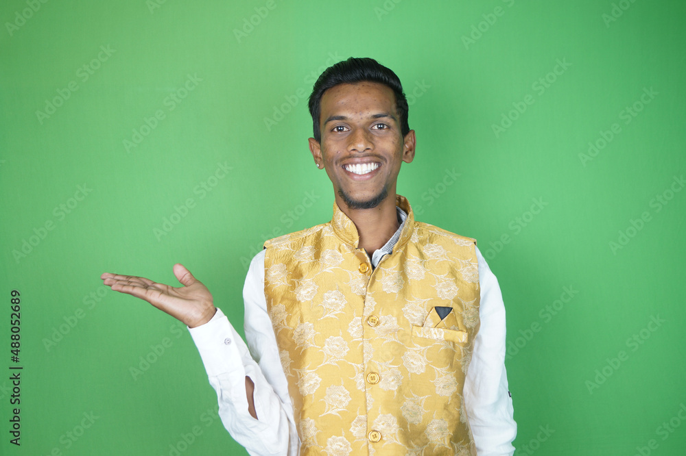 Indian boy smiling with his hand up on the green background Stock Photo ...