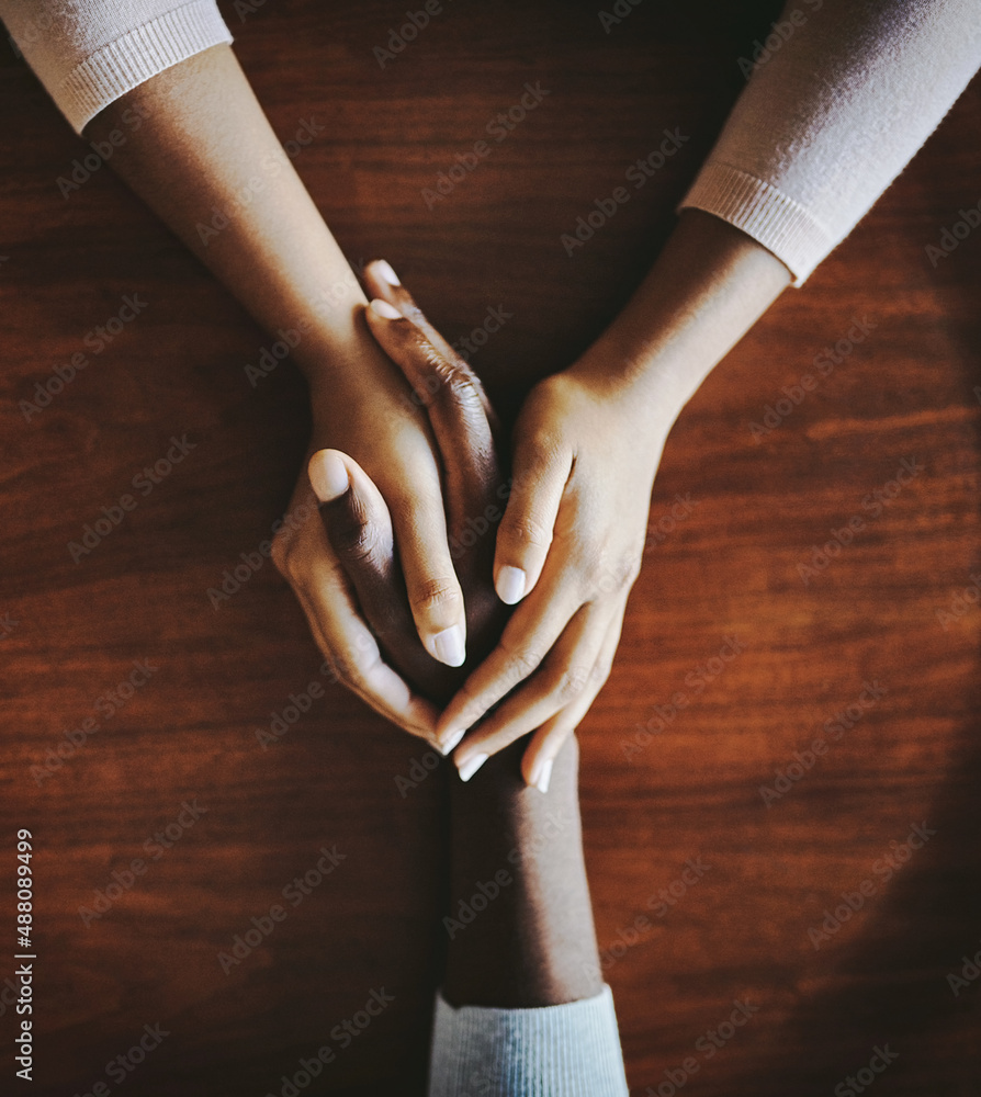 Compassion goes a long way. High angle shot of two people holding hands ...