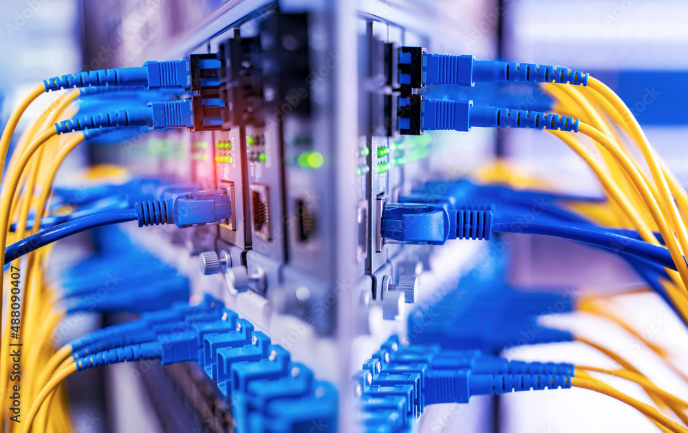 Fiber Optical cables connected to an optic ports and Network cables ...