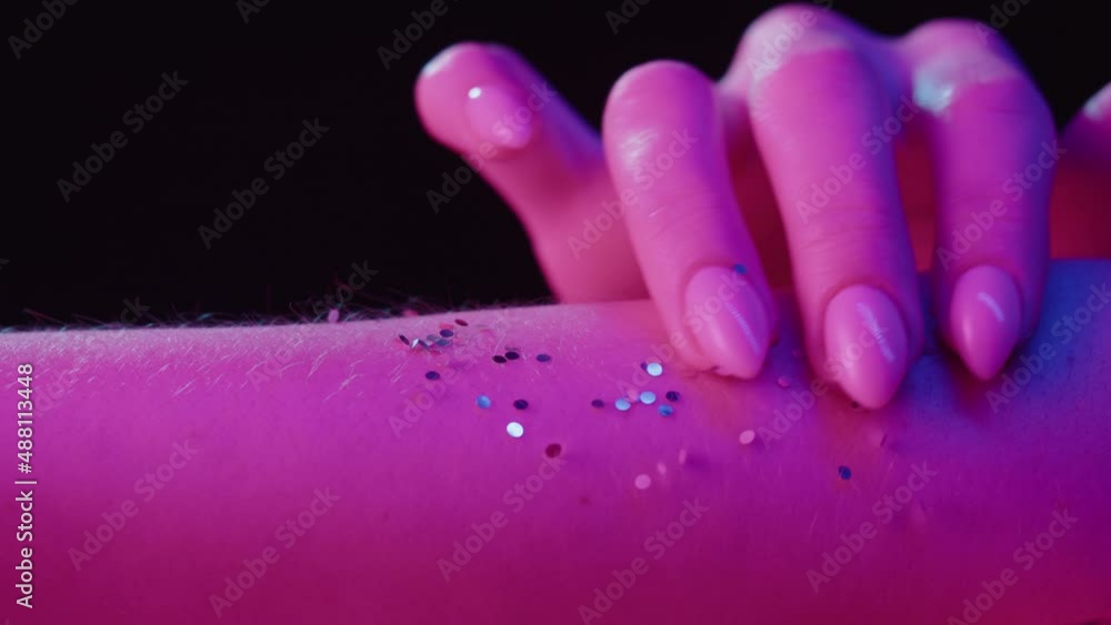 Hand skin in pink neon light, female human body part and ultraviolet ...