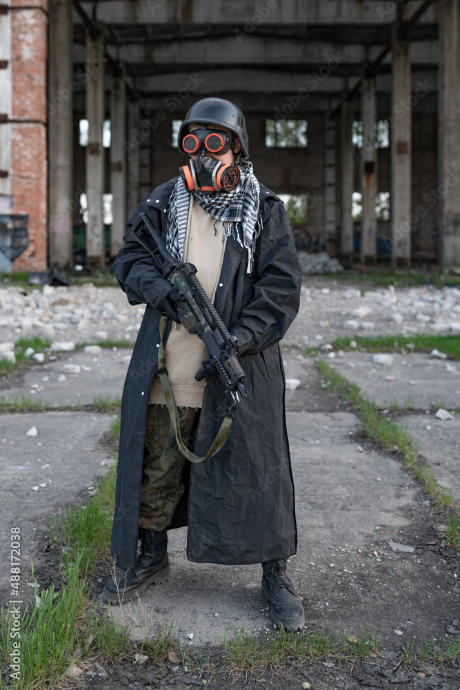 A soldier of the future after the nuclear apocalypse among the ruins ...
