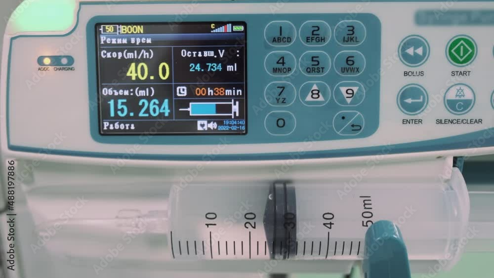 Close-up, working syringe pump monitor. Infusion pump for intravenous ...