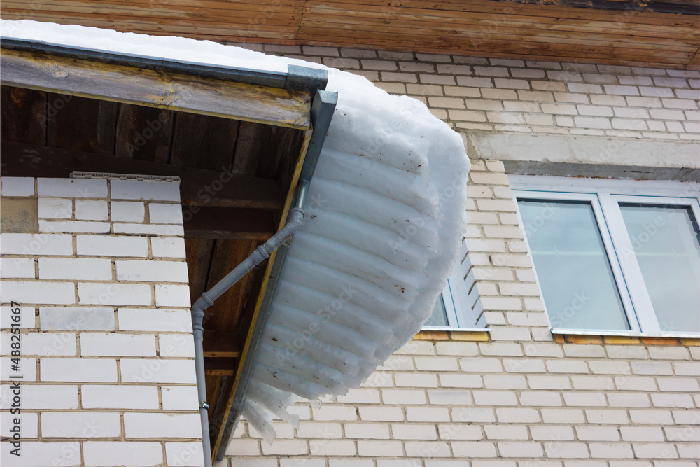 Threat of snow falling from roof. On eve of spring. Place of increased ...