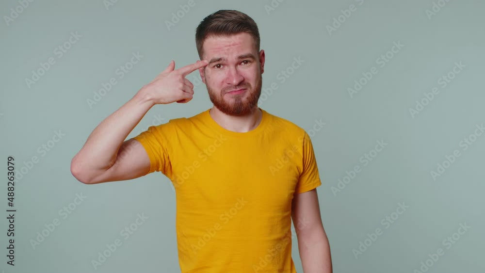 You are crazy, out of mind. Man in yellow t-shirt pointing at camera ...