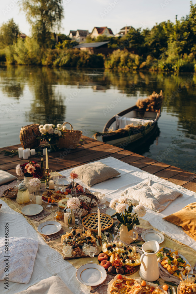 picnic on a wooden jetty near the water. a decorated picnic area ...