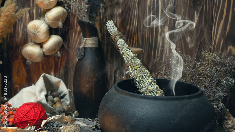 Pagan witch magic altar. Smoking twist of bitter wormwood herb for ...