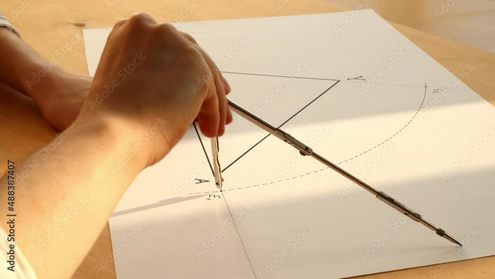 Young mathematician hands are drawing an arc of a circle for ...