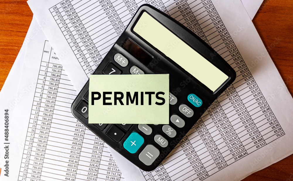 PERMITS word on sticker and calculator above permits and approved ...