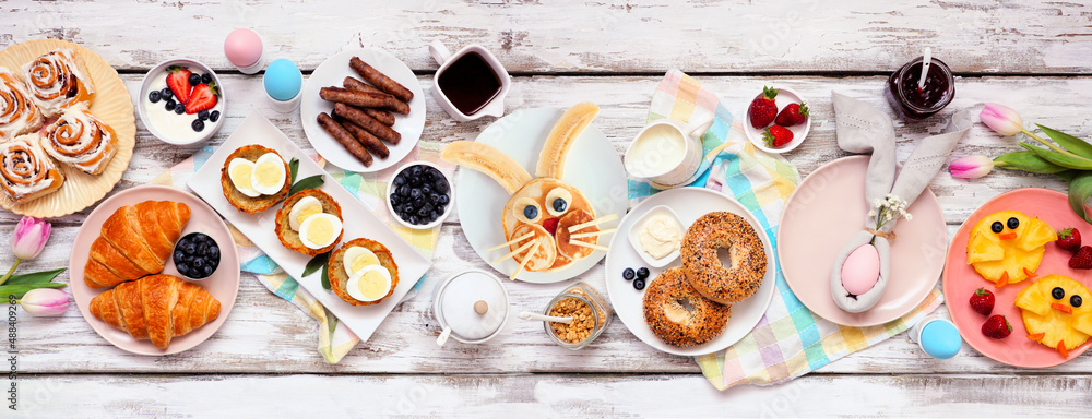 Easter breakfast or brunch table scene. Overhead view on a white wood ...