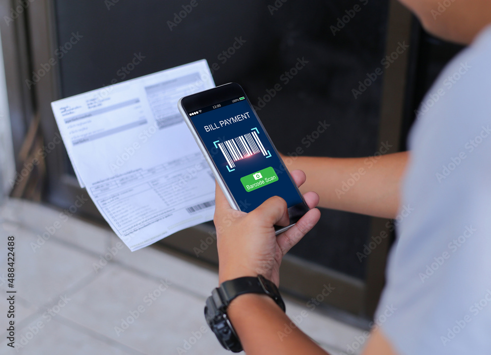 Mobile bill payment barcode scan concept.Man hands using mobile phone ...