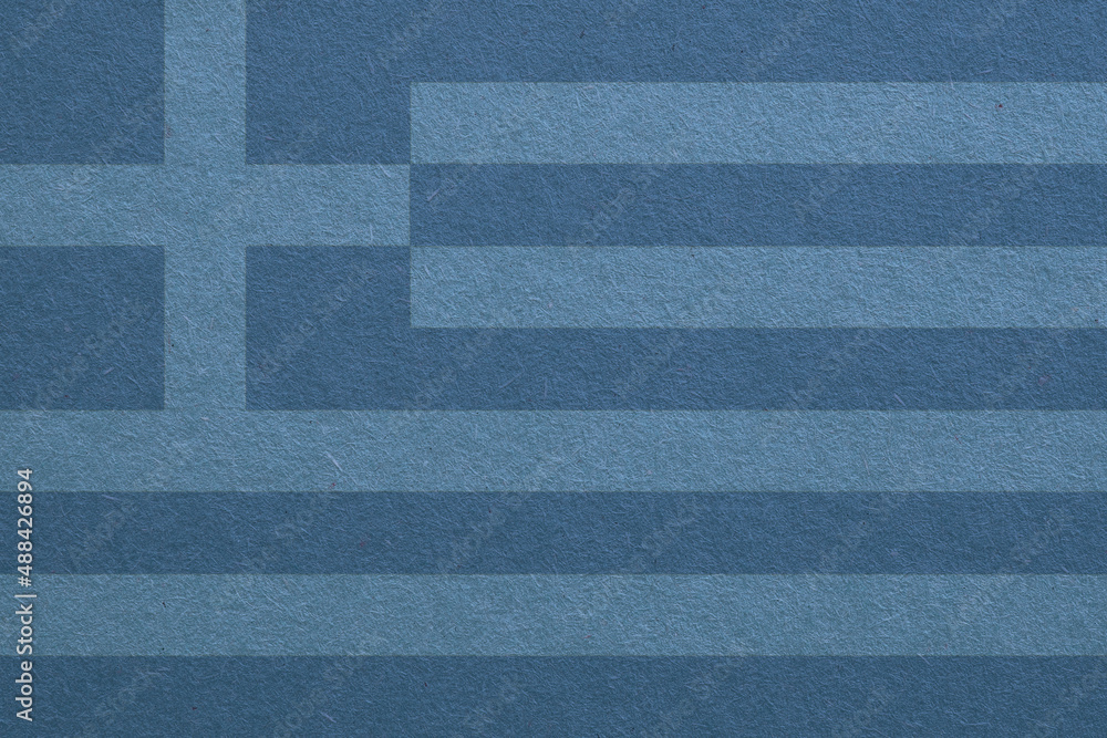 Greek flag outline on blue cardboard surface. Paper texture with ...