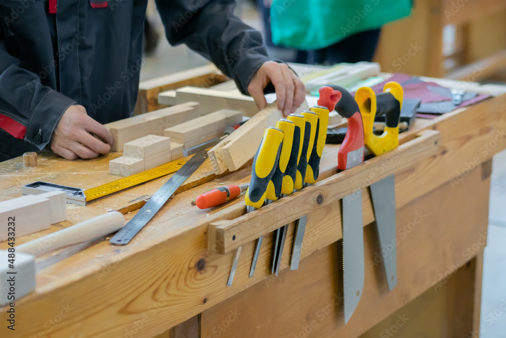 Professional man carpenter working with wooden detail - assembling ...