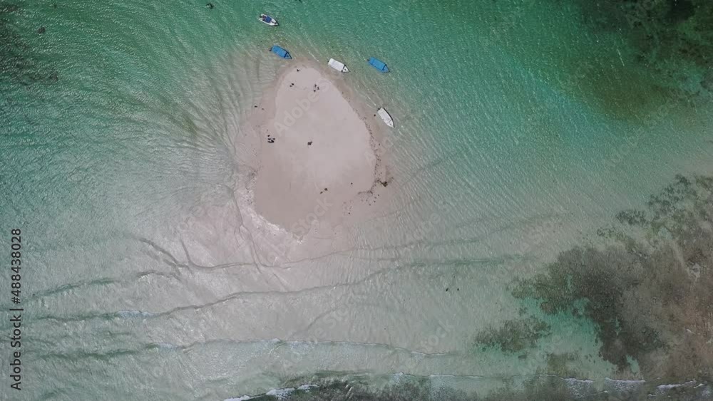 Top view of sandbank with white sand and boats around small island ...